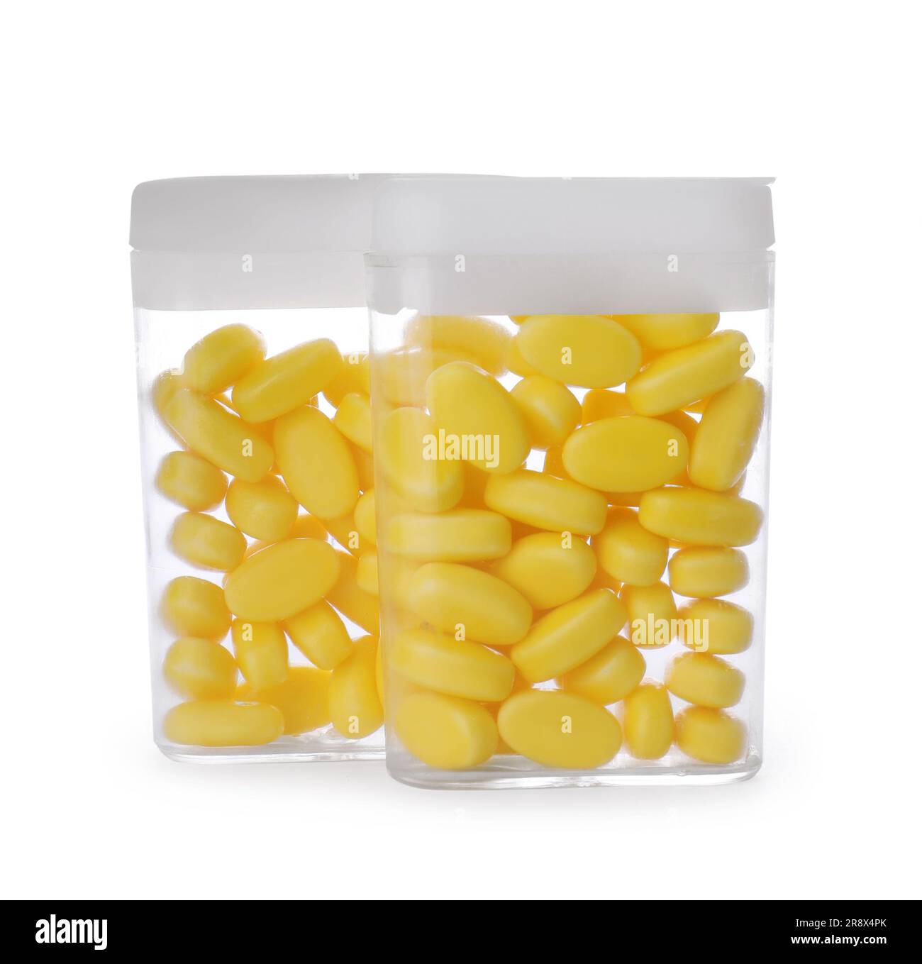 Boxes of tasty yellow dragee candies on white background Stock Photo ...
