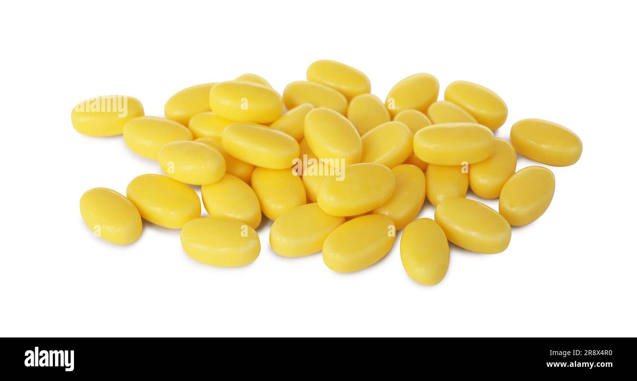 Tasty yellow dragee candies on white background Stock Photo - Alamy