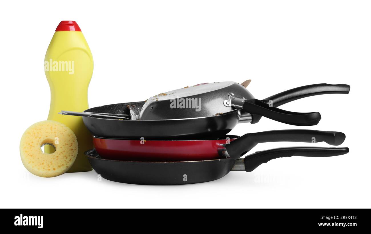 Stack of dirty kitchenware, dish detergent and sponge on white ...