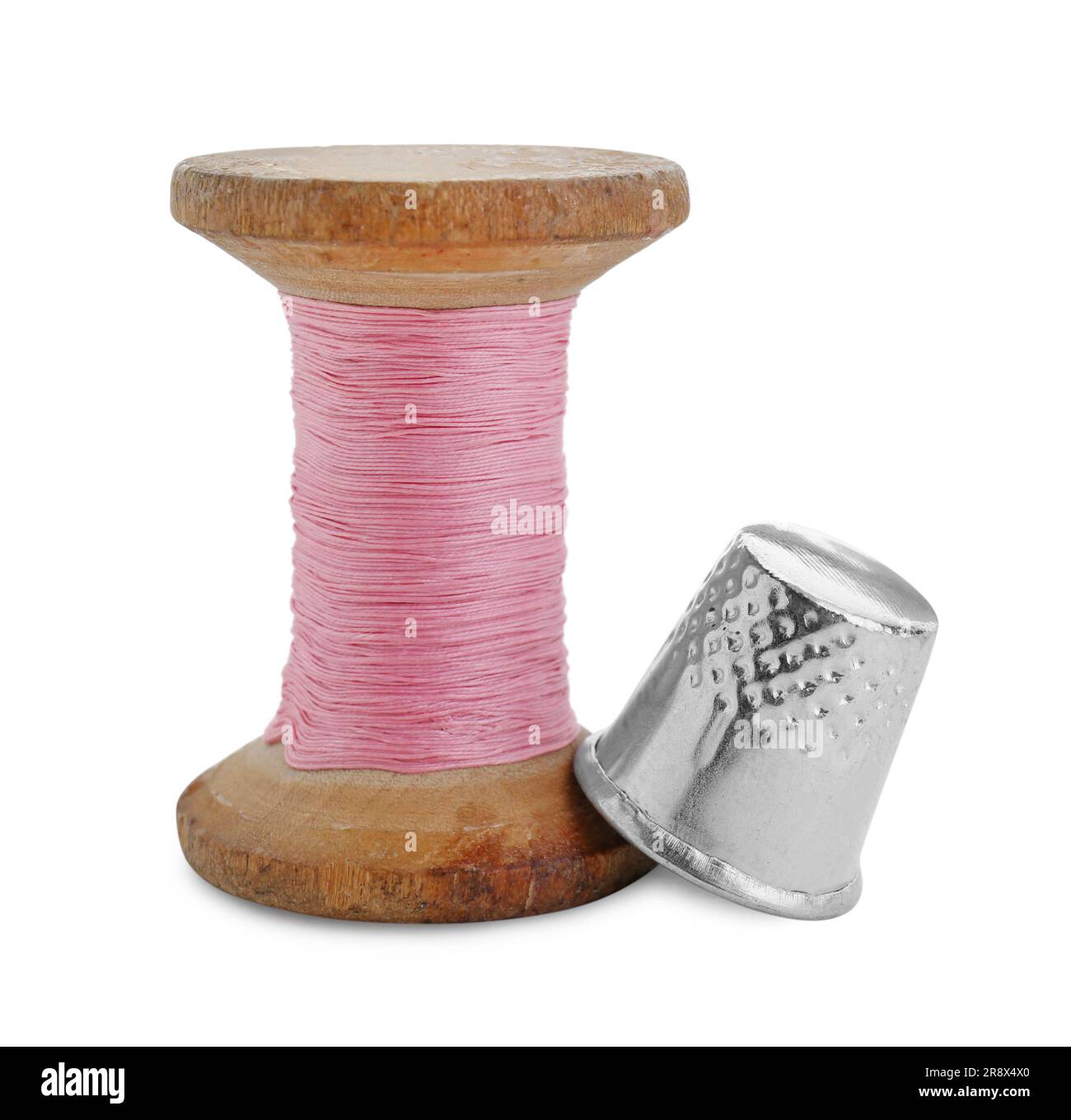 Thimble and spool of sewing thread isolated on white Stock Photo - Alamy
