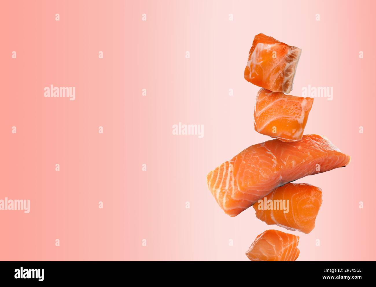 Cut fresh salmon falling on pink gradient background, space for text ...