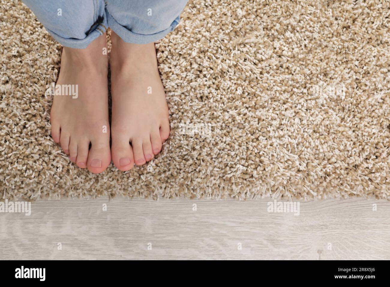 Woman standing on soft carpet at home, top view Stock Photo - Alamy
