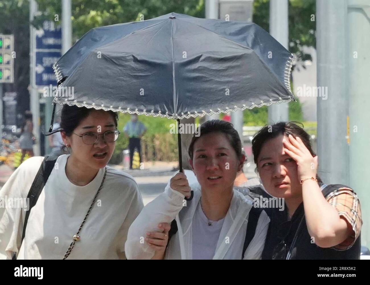 People walk in record-breaking heat wave in Beijing, China on June 23 ...