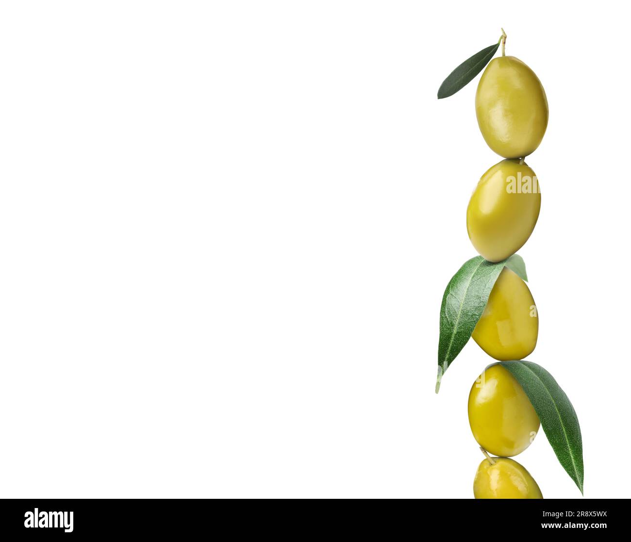 Stack of whole green olives with leaves on white background Stock Photo ...