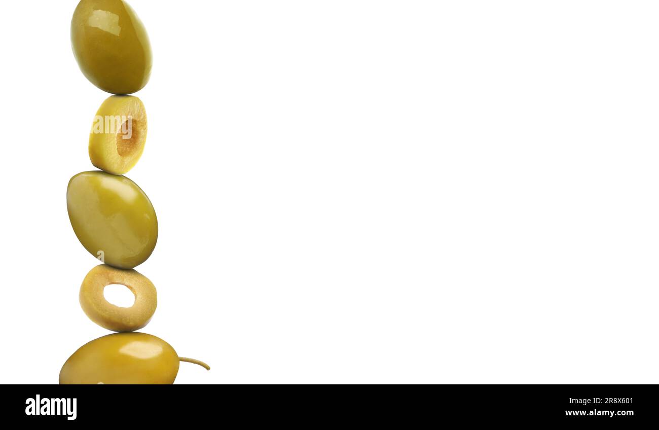 Cut and whole green olives on white background Stock Photo - Alamy