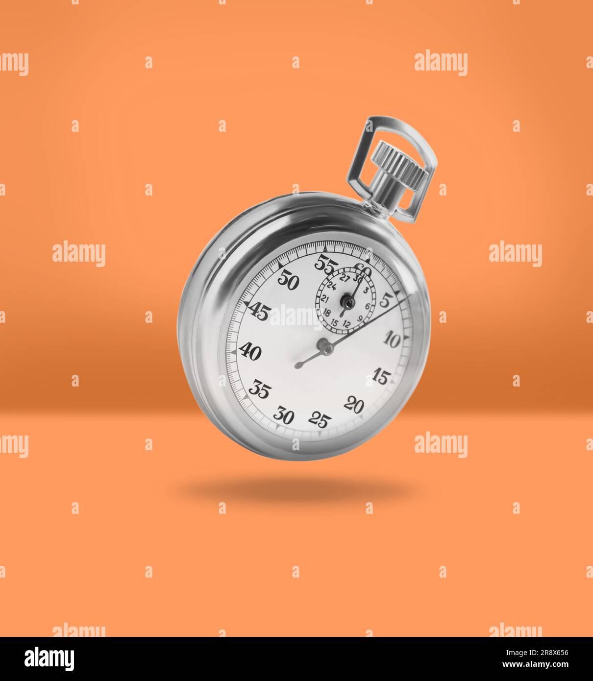 Concept of time. Vintage timer in air on orange background Stock Photo ...