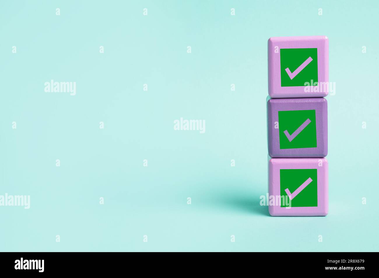 Stacked cubes with check marks on turquoise background. Space for text ...