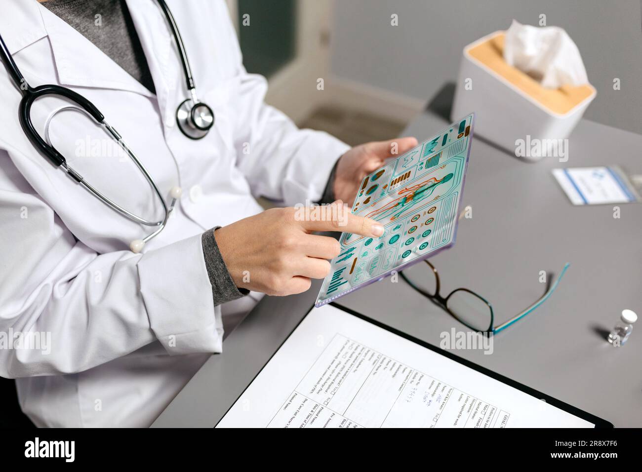 Female doctor touching transparent tablet with medical digital ...