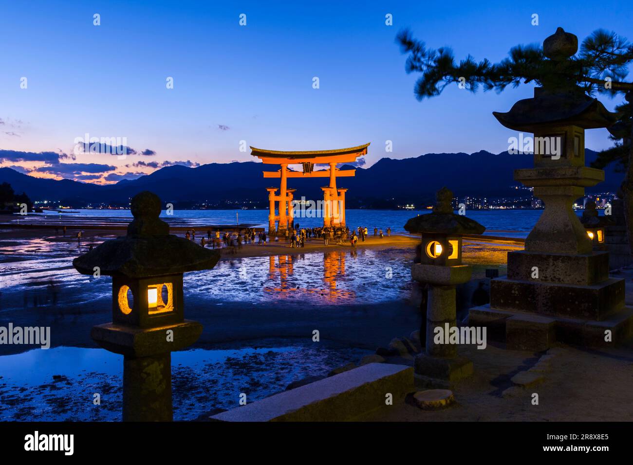 The large gate of Itsukushima Shrine lit up Stock Photo - Alamy