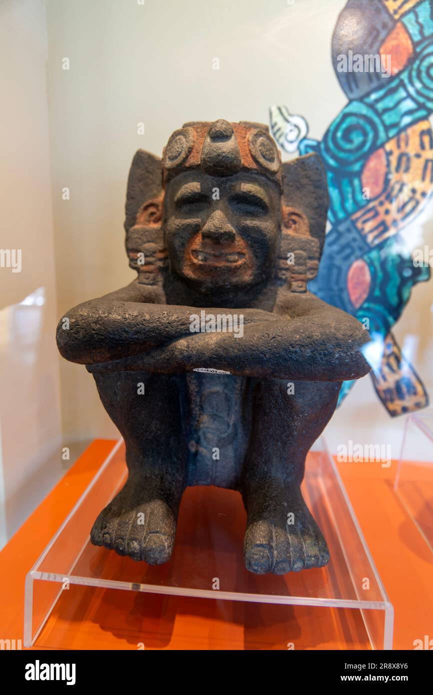 Carved stone crouching figure of god of fire, day and heat Xiuhtecuhtli ...