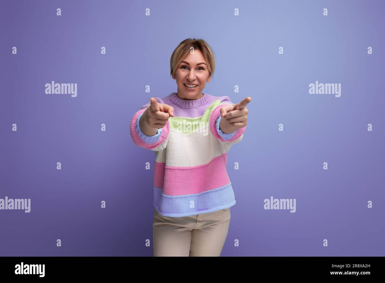 charming blond young woman showing class ahead on purple background ...