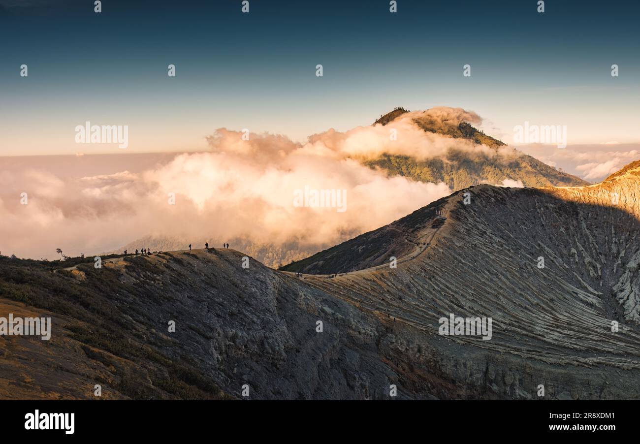 Landscape top of rugged active crater volcano with tourist trekking on ...