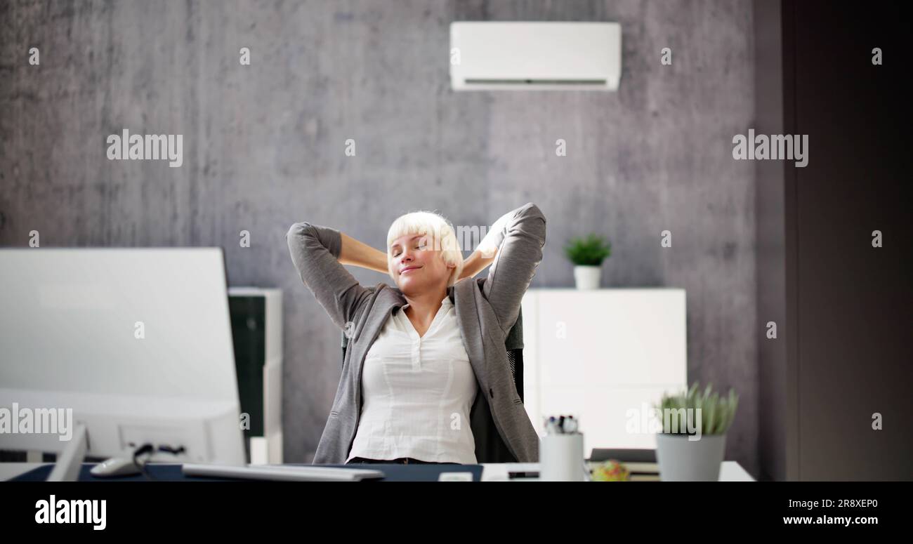 Relaxed Businesswoman Enjoying The Cooling Of Air Conditioner In The ...