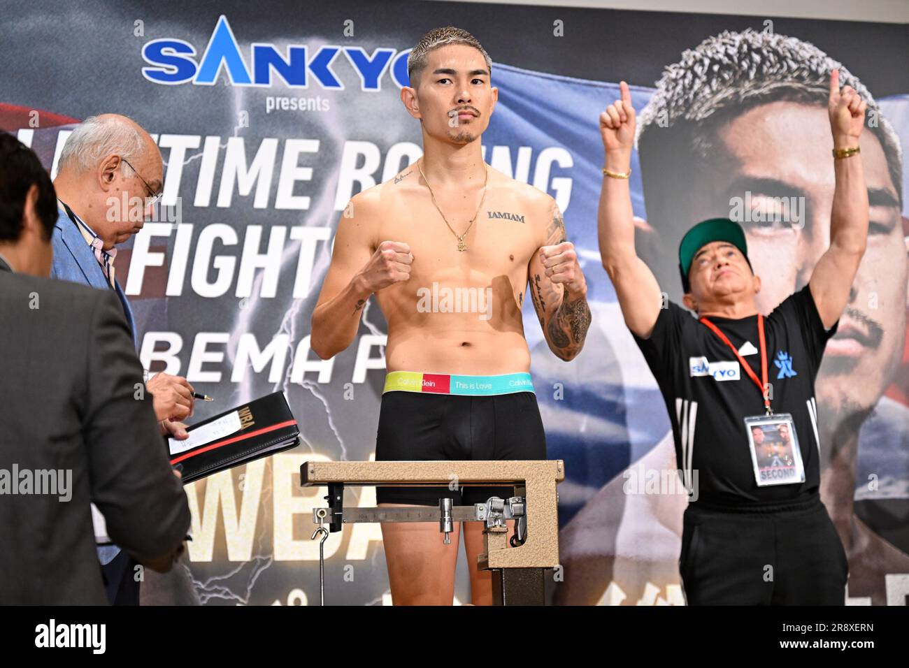 Kazuto Ioka of Japan poses during the weigh-in as his trainer Ismael ...