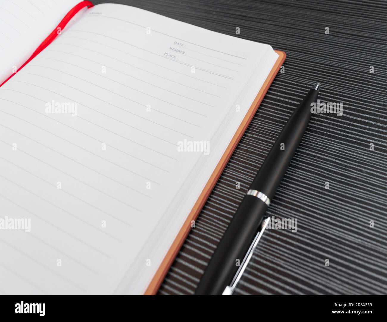 A pen and book placed on textured table, after some edits Stock Photo ...