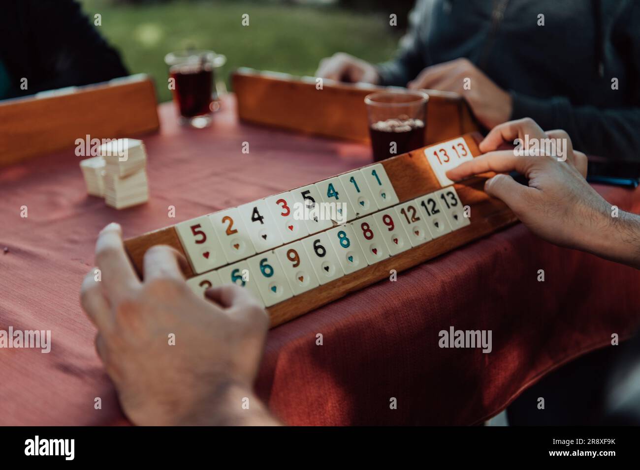 A group of men drink traditional Turkish tea and play a Turkish game ...