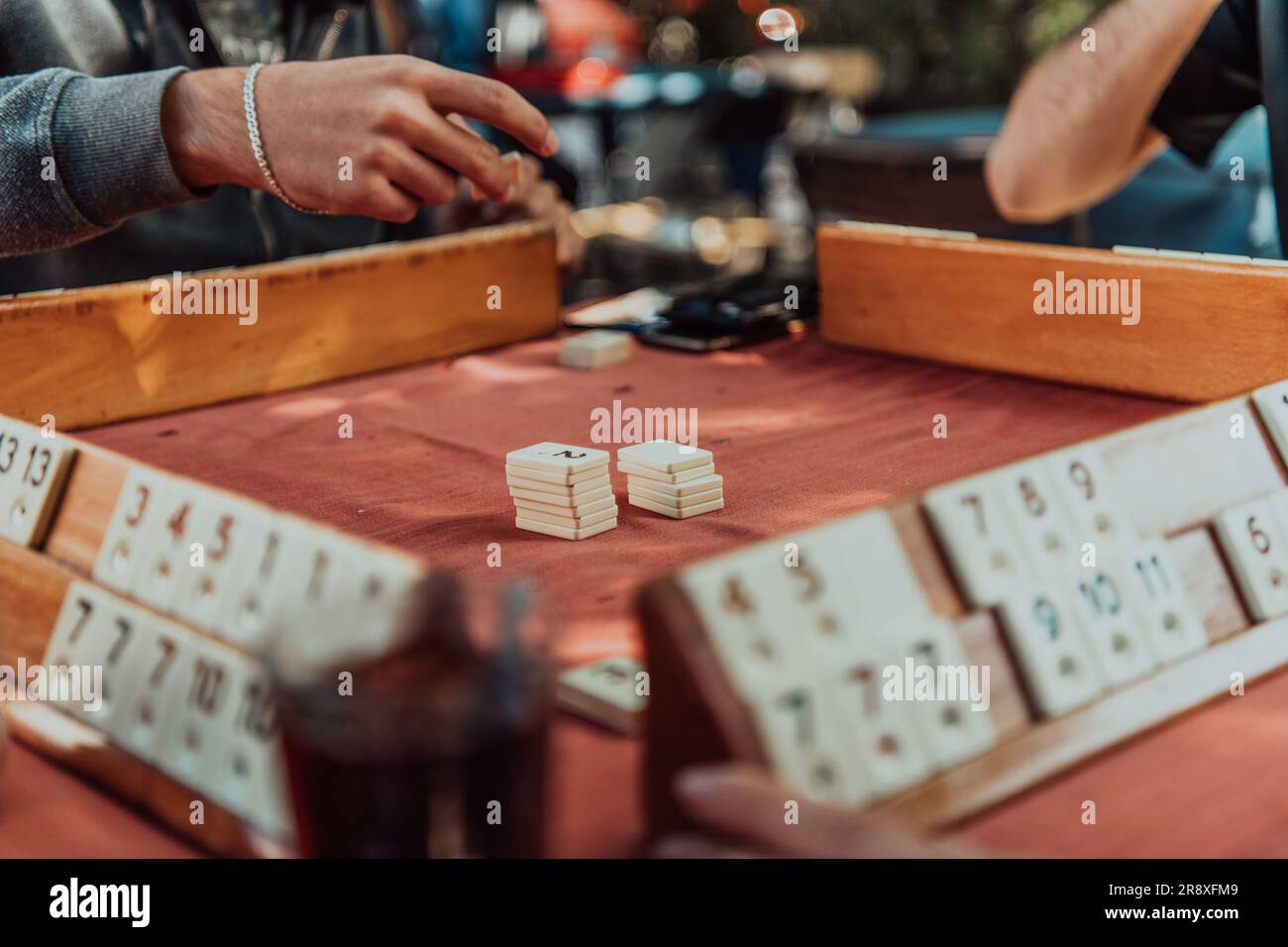 A group of men drink traditional Turkish tea and play a Turkish game ...