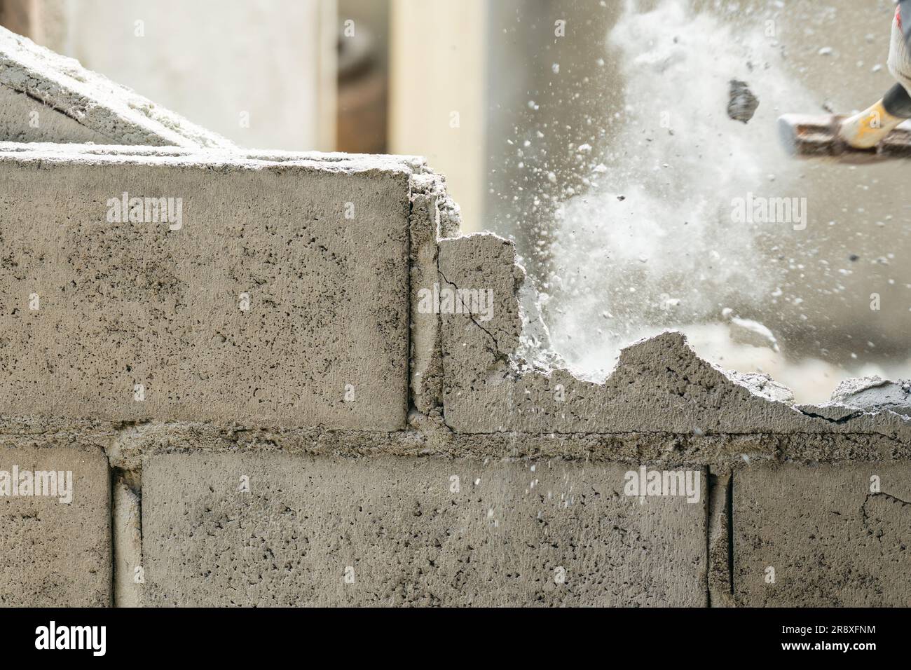 Hand of worker using hammer smashing and demolish on brick block wall ...