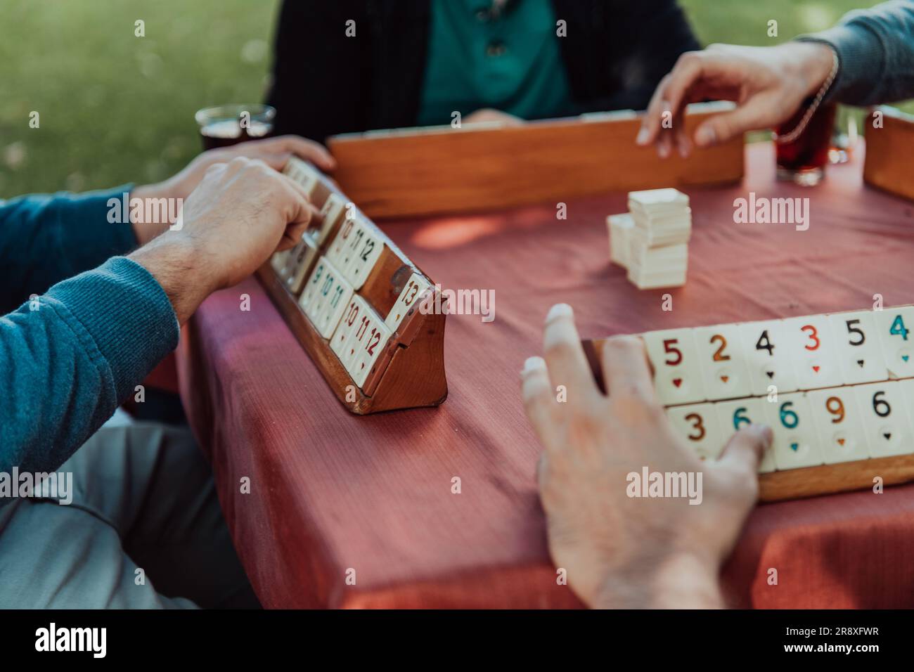 A group of men drink traditional Turkish tea and play a Turkish game ...