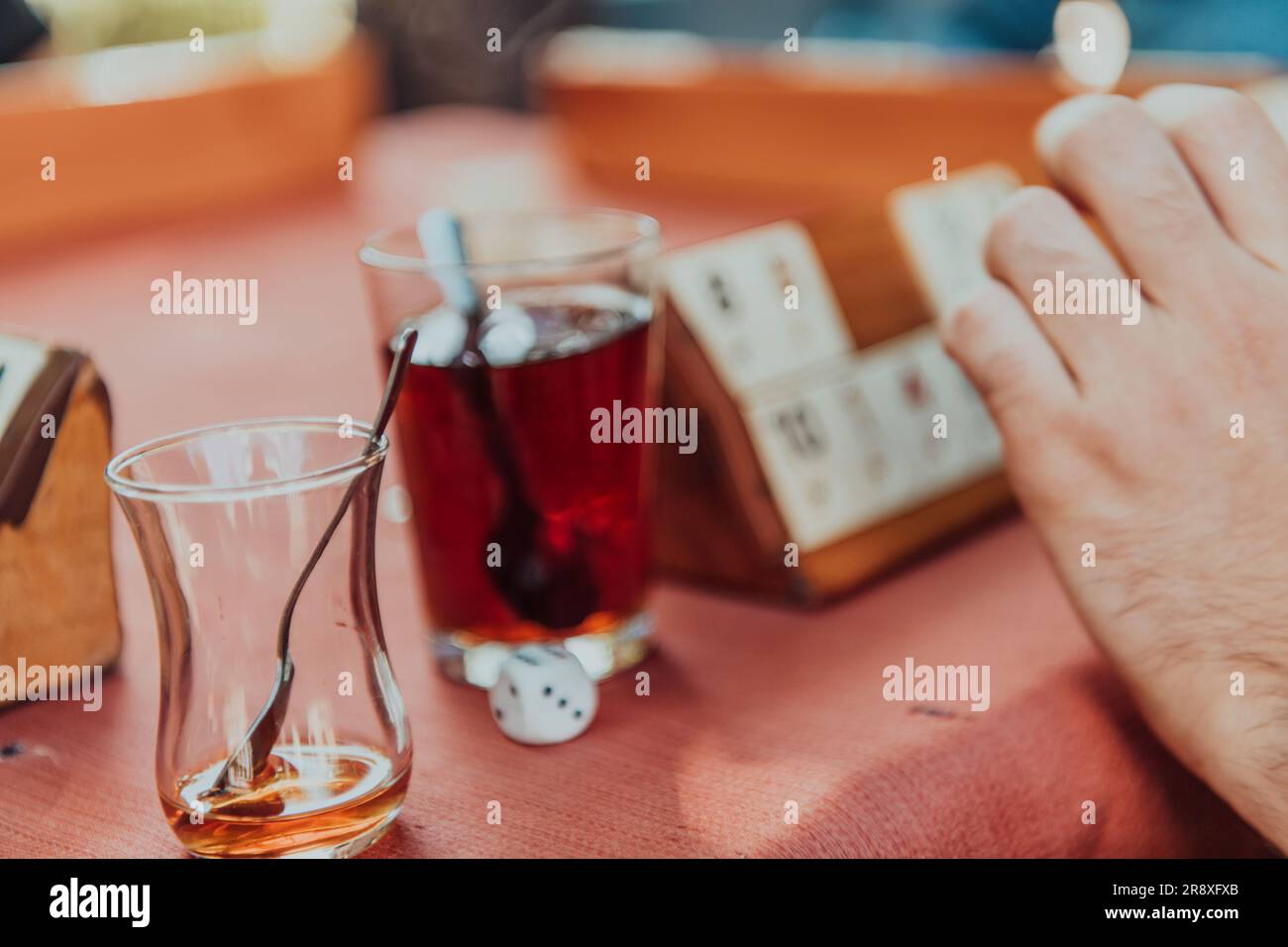 A group of men drink traditional Turkish tea and play a Turkish game ...