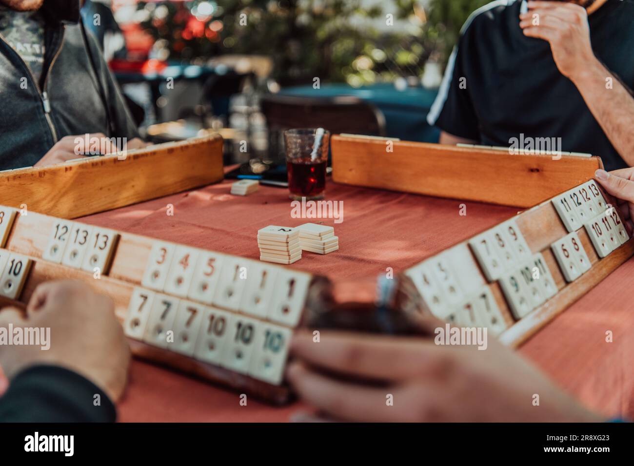 A group of men drink traditional Turkish tea and play a Turkish game ...