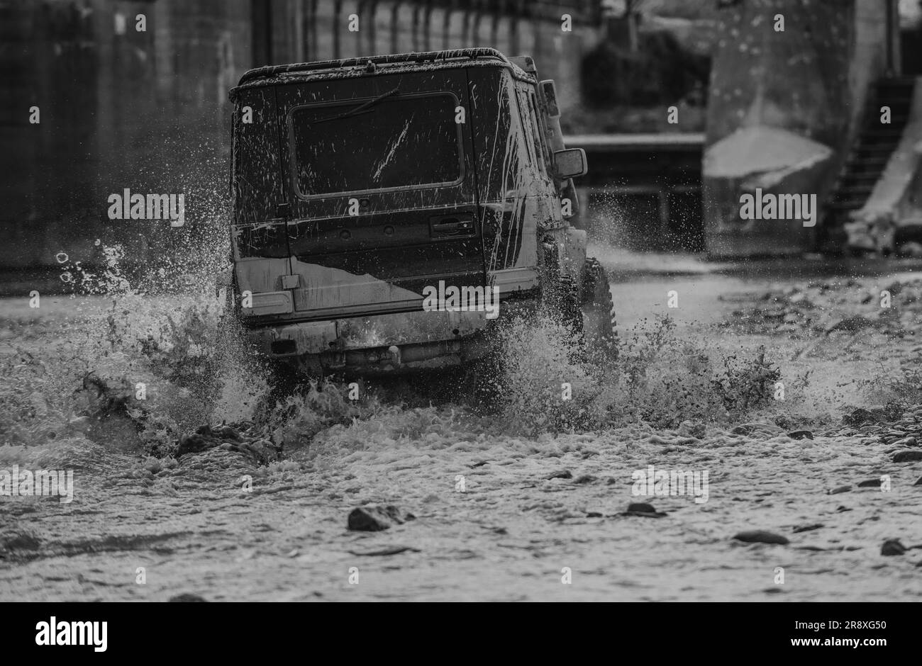 Offroad vehicle coming out of a mud hole hazard. Safari suv. Off-road ...
