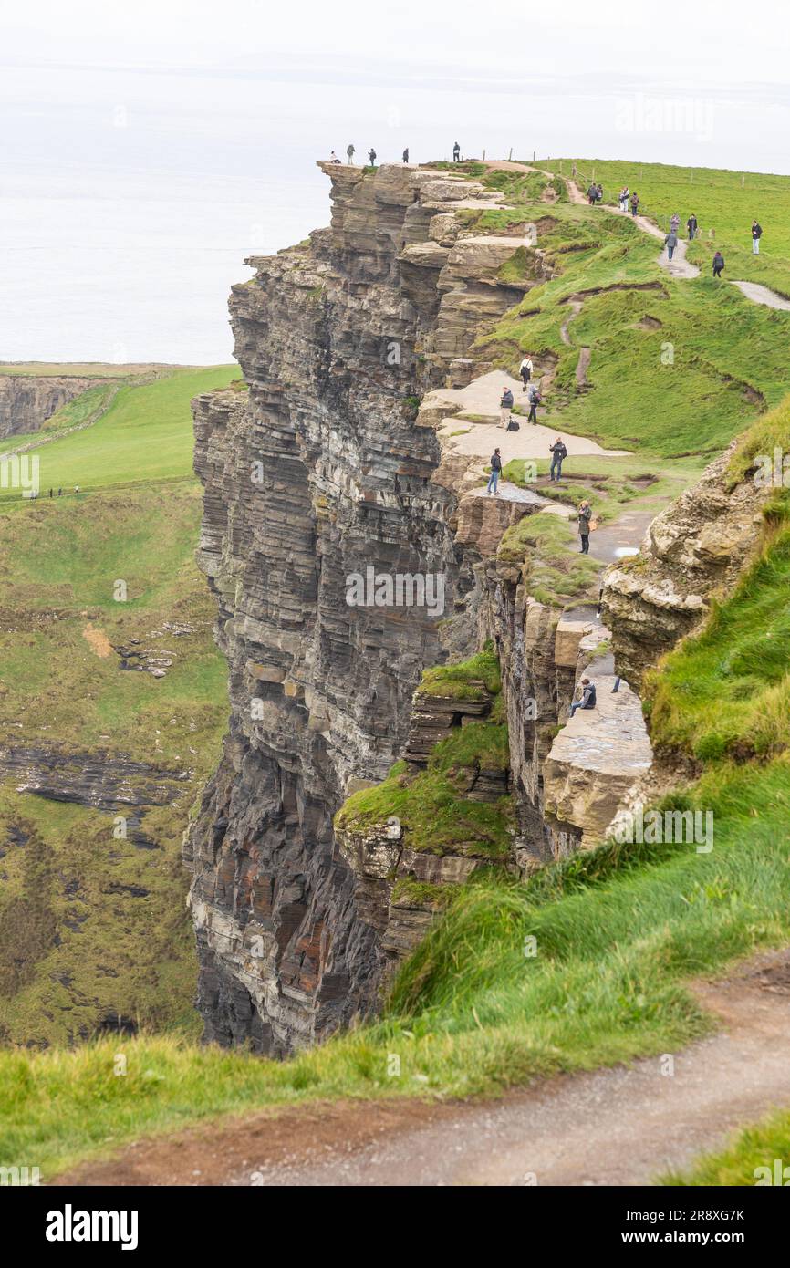 People take high risk by walking on cliff edge at Cliffs of Moher in ...