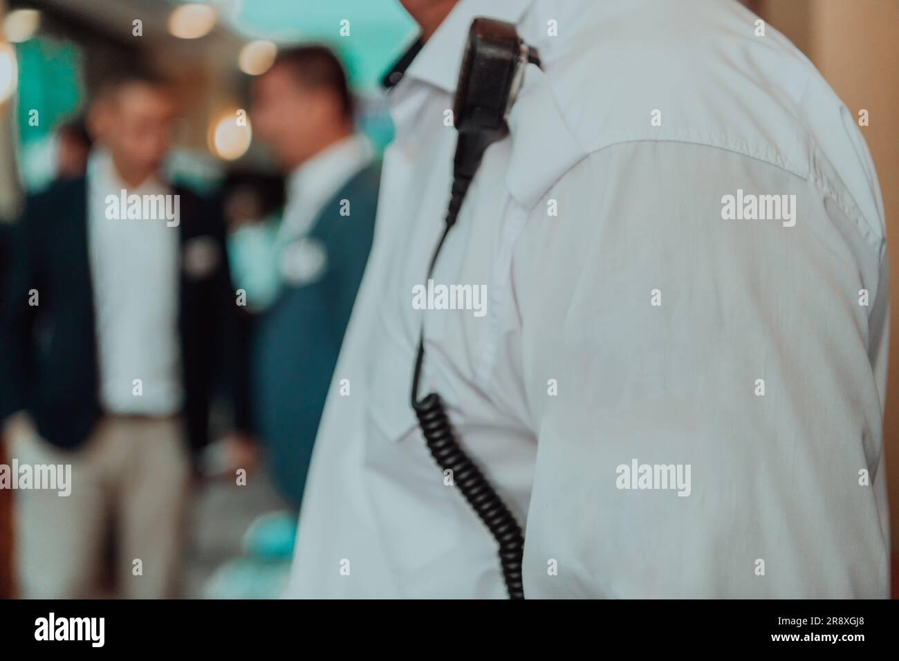 A close-up photo of a guard holding a communication device Stock Photo ...