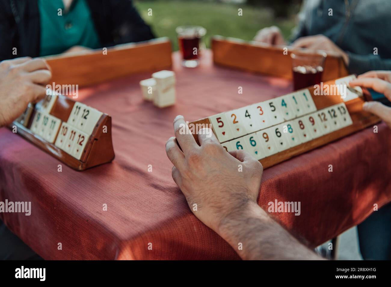 A group of men drink traditional Turkish tea and play a Turkish game ...
