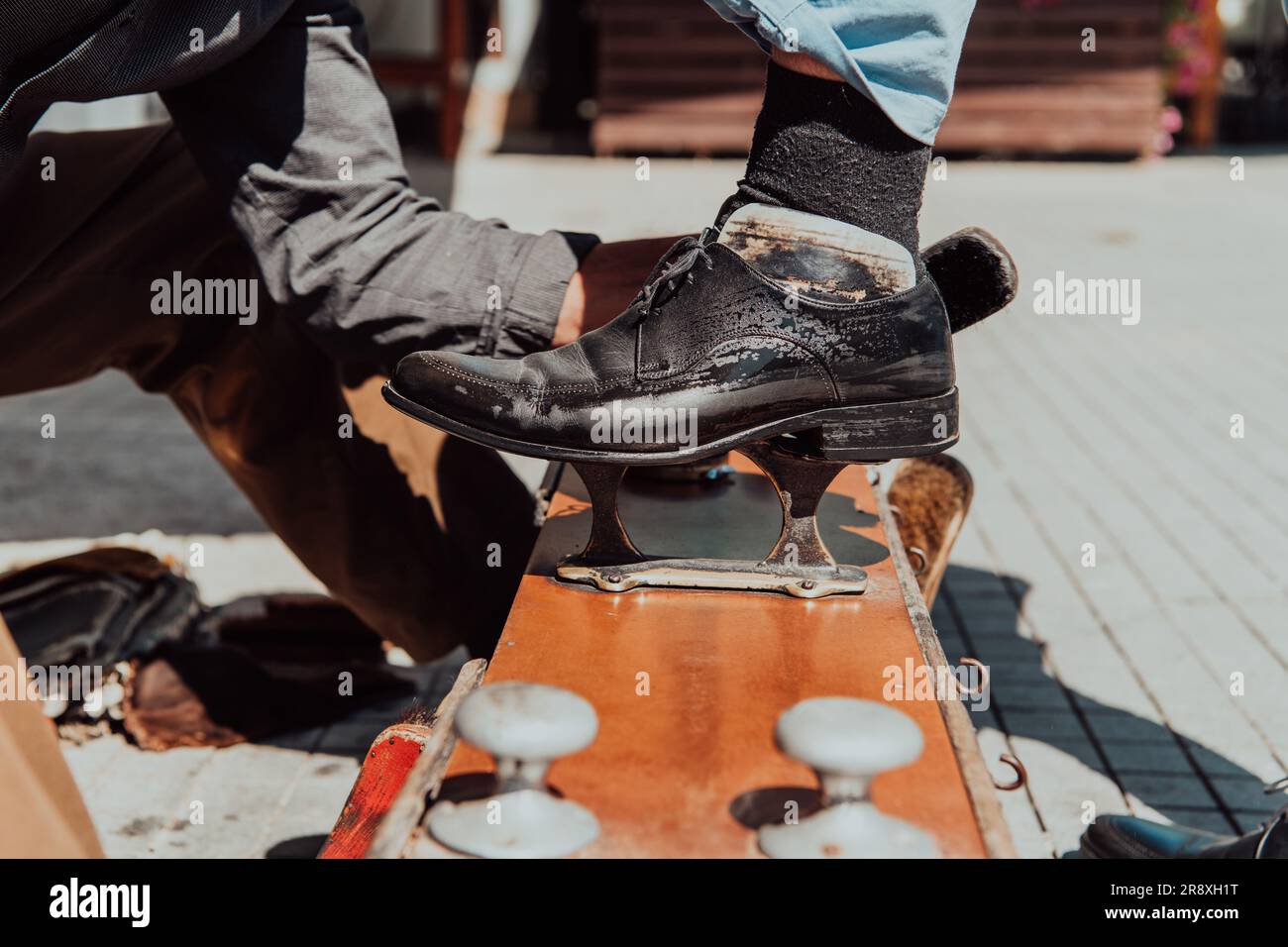 An old man hand polishing and painting a black shoe at street Stock ...