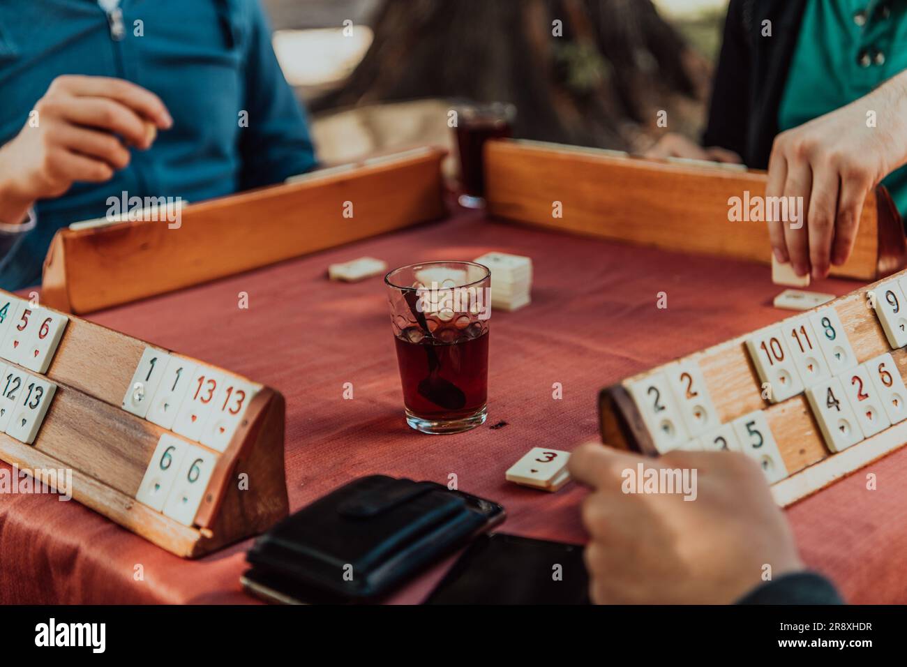 A group of men drink traditional Turkish tea and play a Turkish game ...