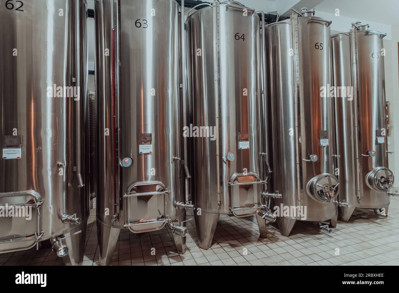 Modern wine distillery and brewery with brew kettles pipes and ...