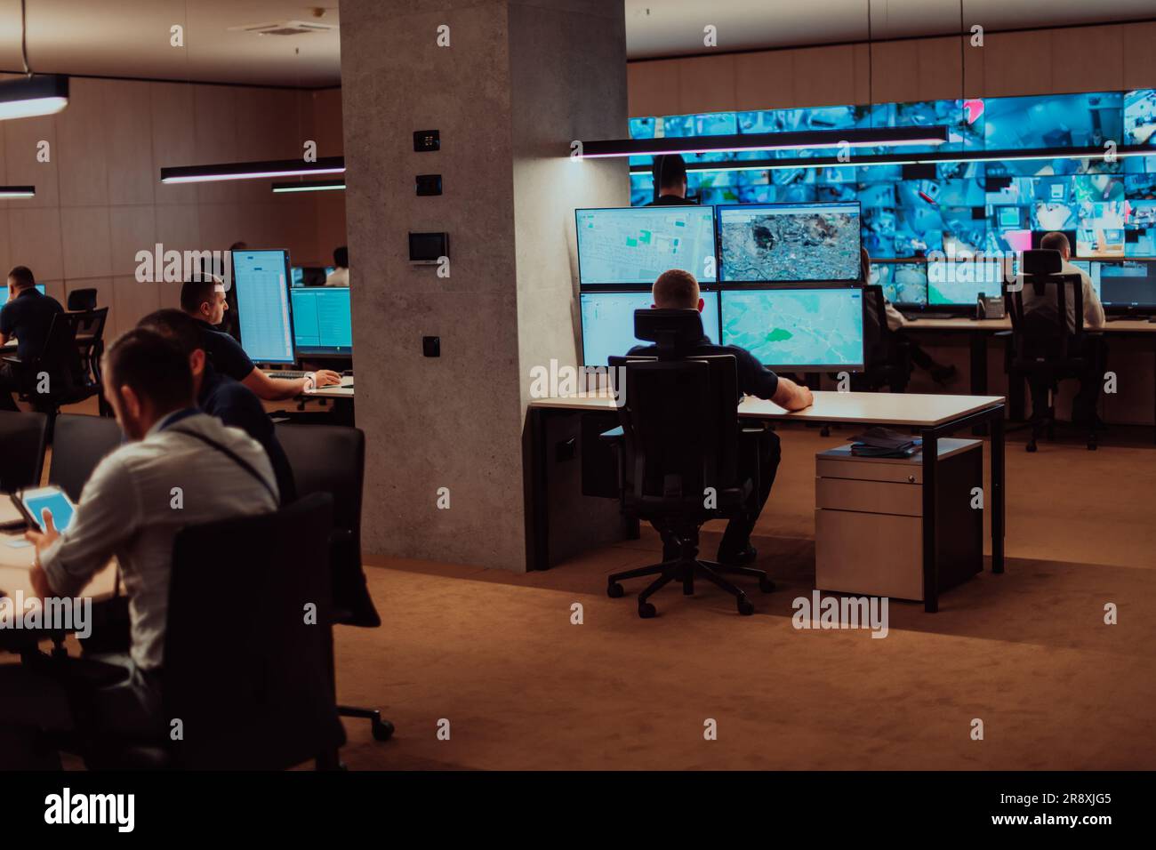 Group of Security data center operators working in a CCTV monitoring ...