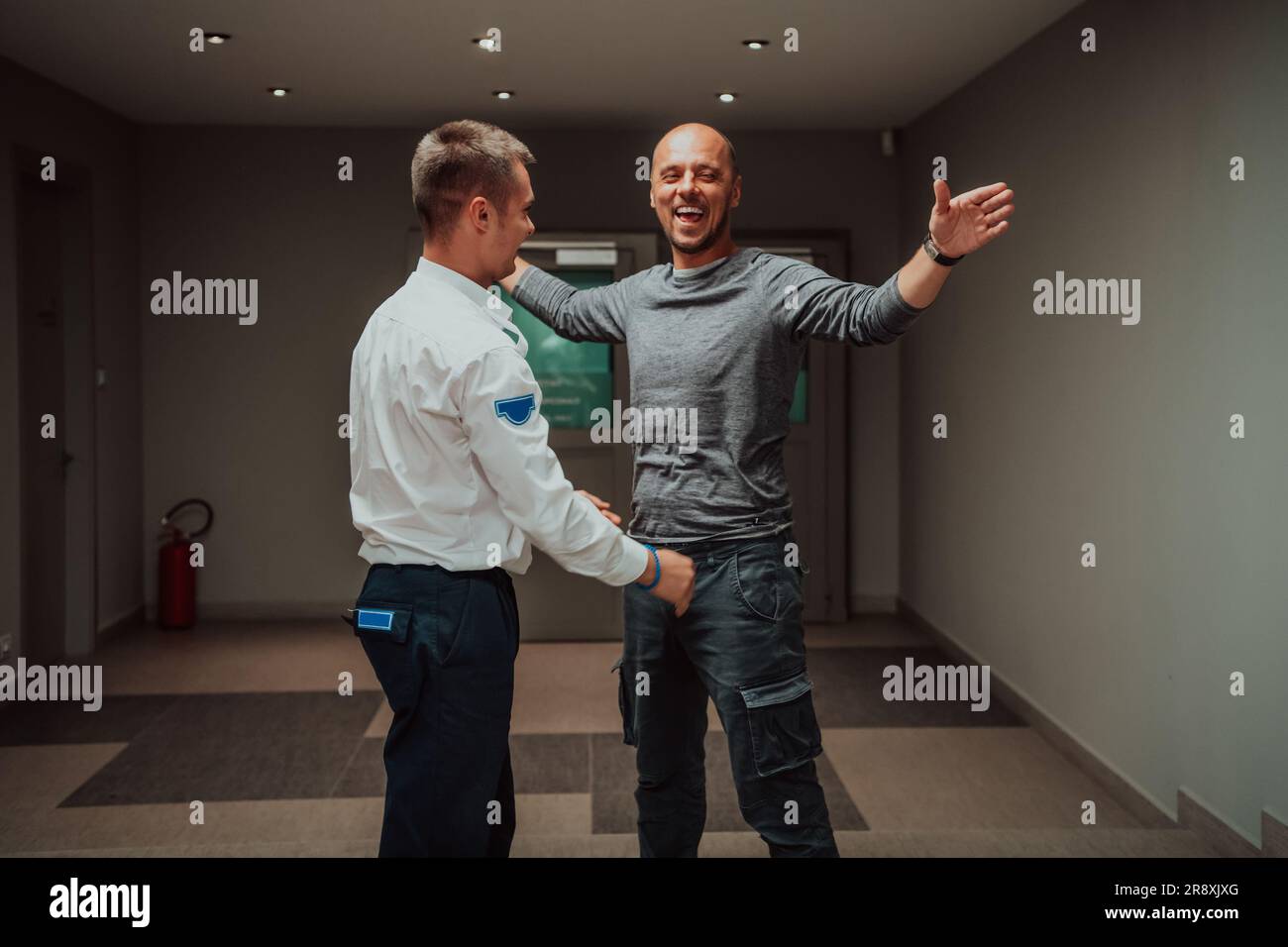 Security guard making body searching procedure on man for finding ...