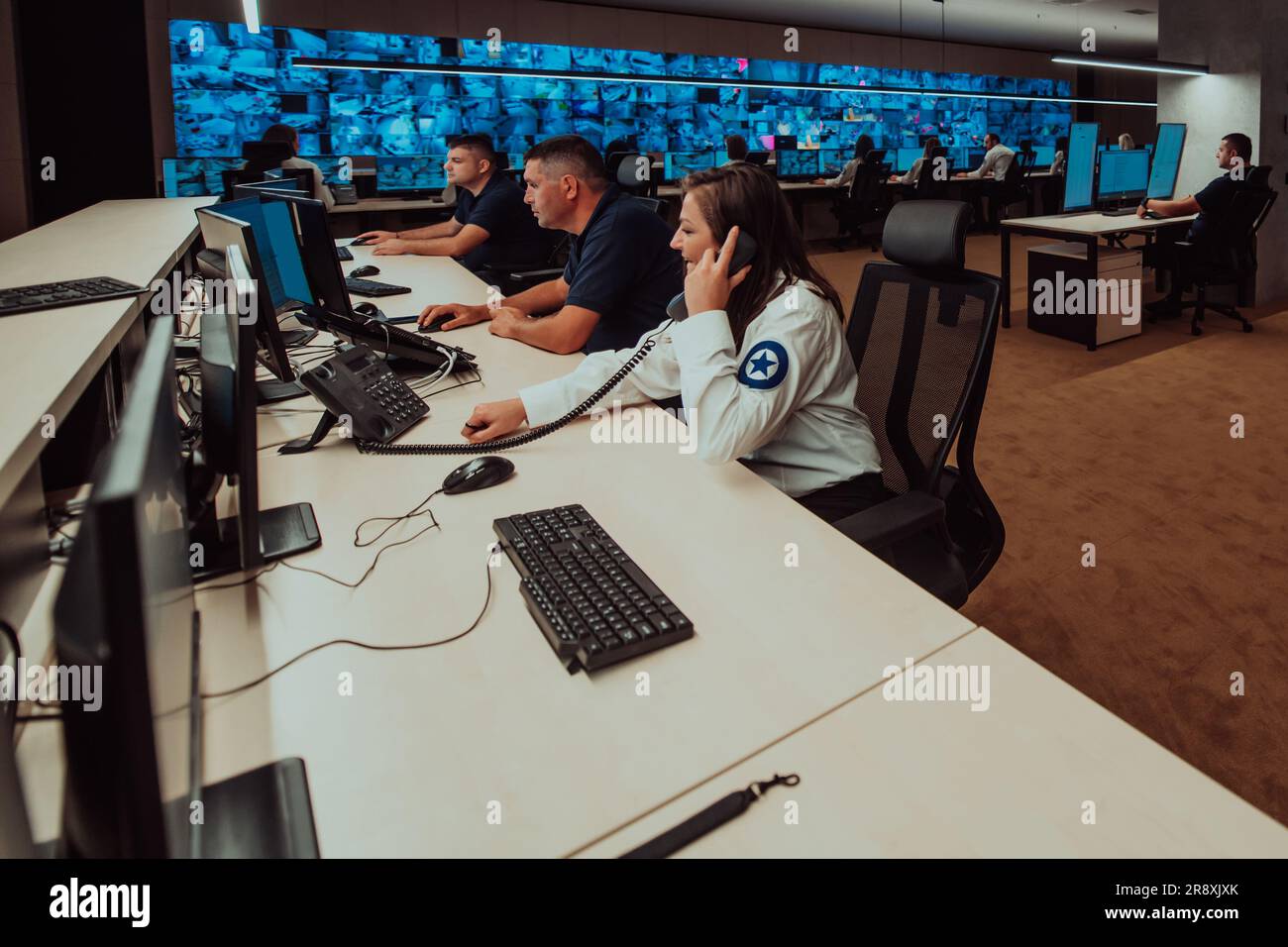 Group of Security data center operators working in a CCTV monitoring ...