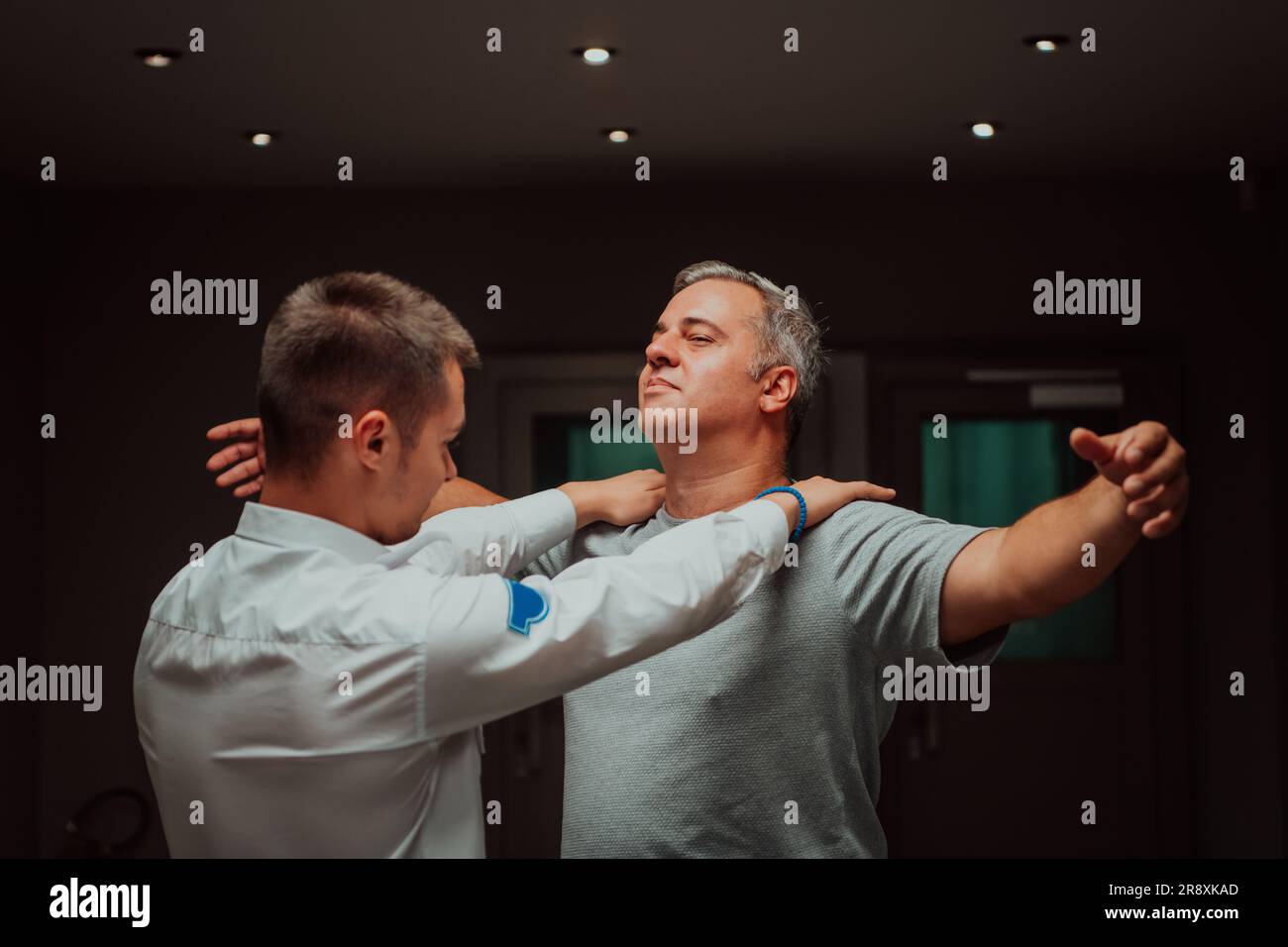 Security guard making body searching procedure on man for finding ...