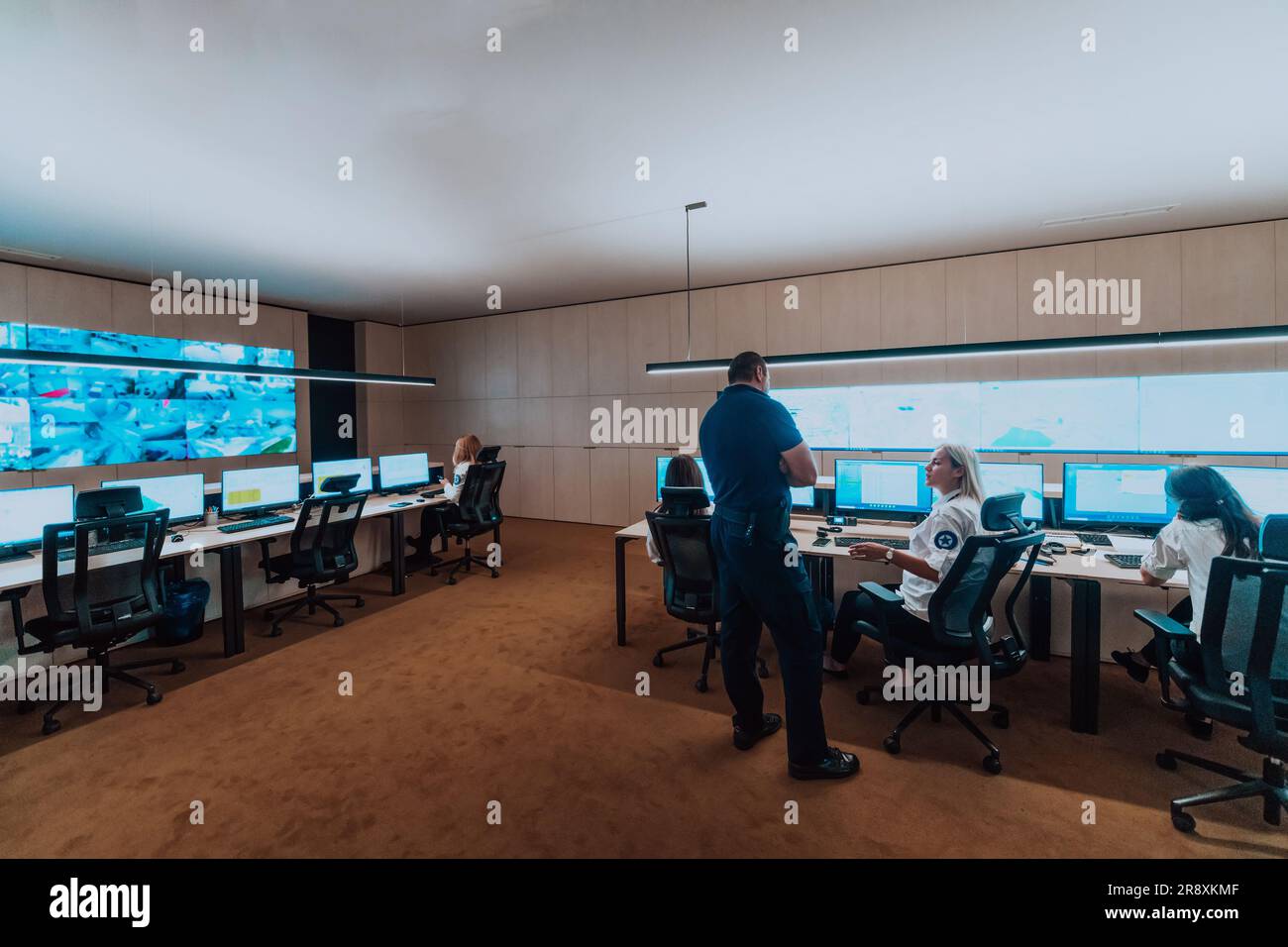 Group of security operators working in a data system control room ...