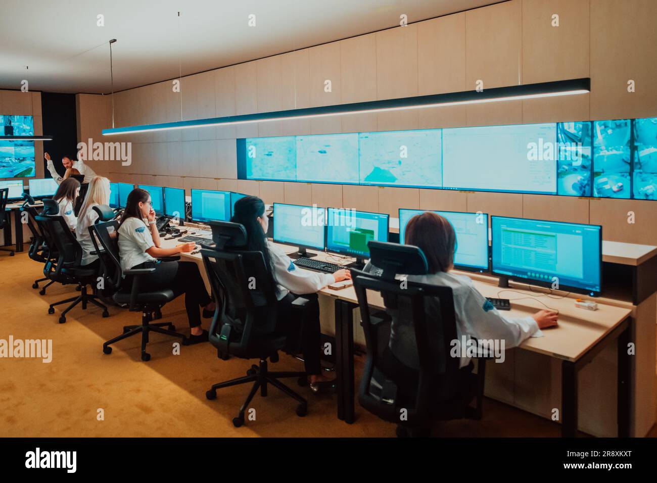Group of Security data center operators working in a CCTV monitoring ...