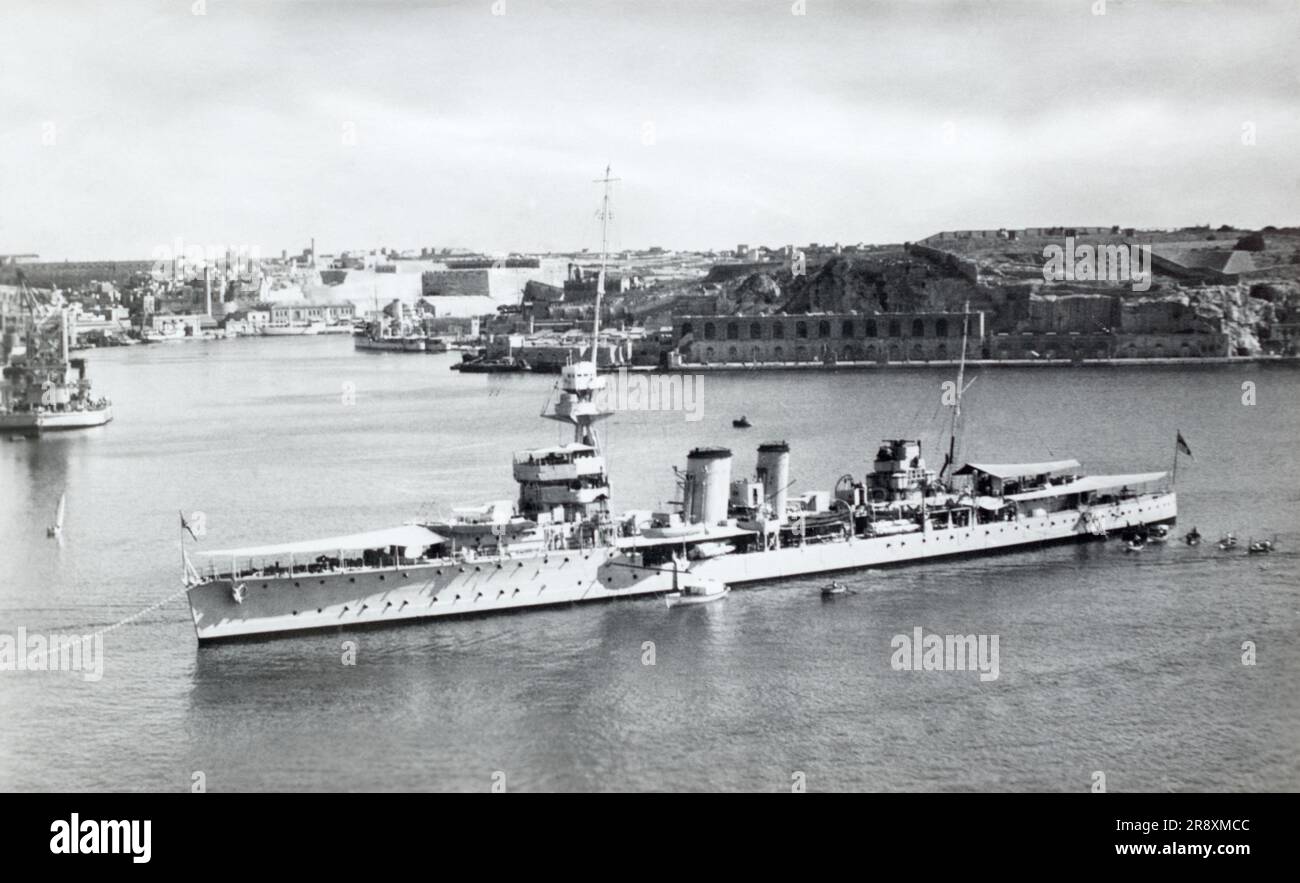 A Royal Navy light cruiser anchored in a harbour Stock Photo - Alamy