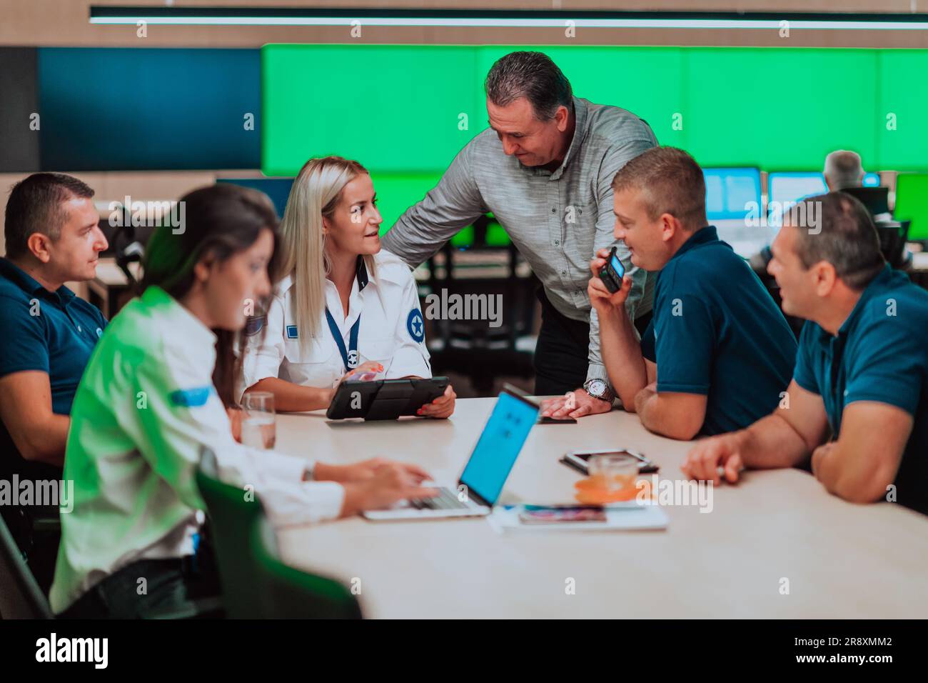 Group of security guards sitting and having briefing In the system ...
