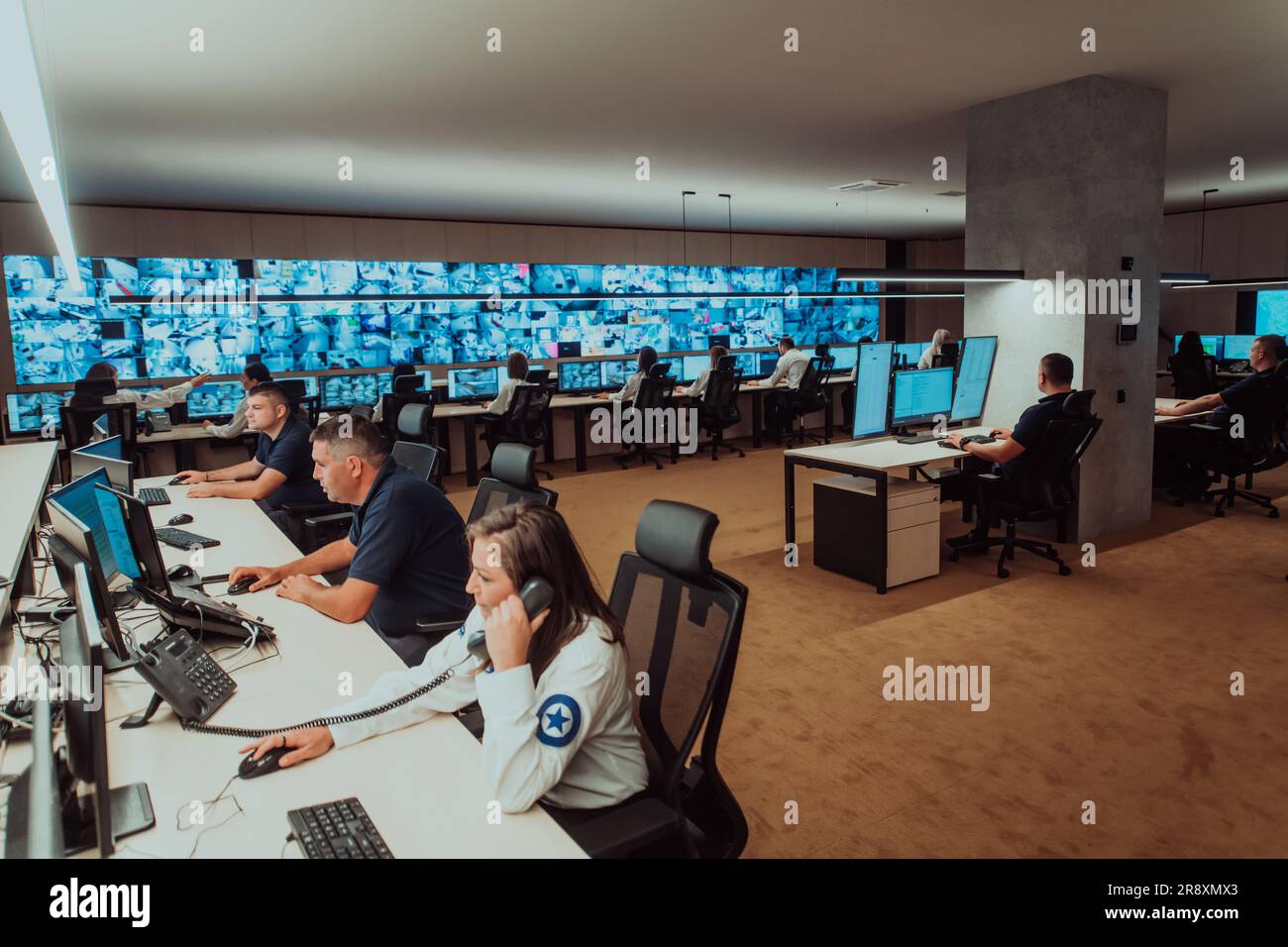 Group of Security data center operators working in a CCTV monitoring ...