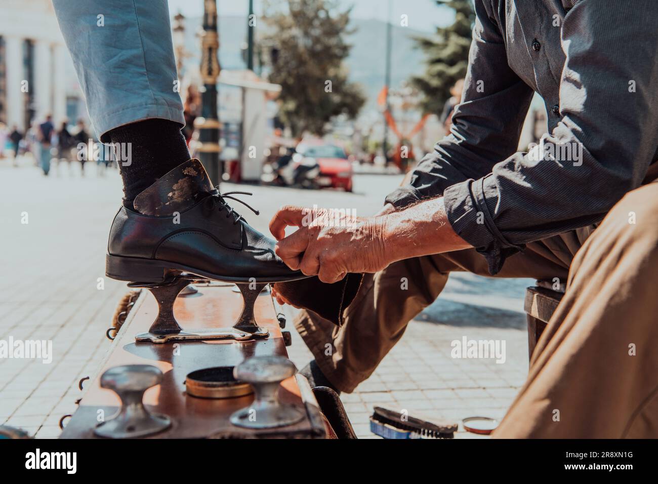 An old man hand polishing and painting a black shoe at street Stock ...