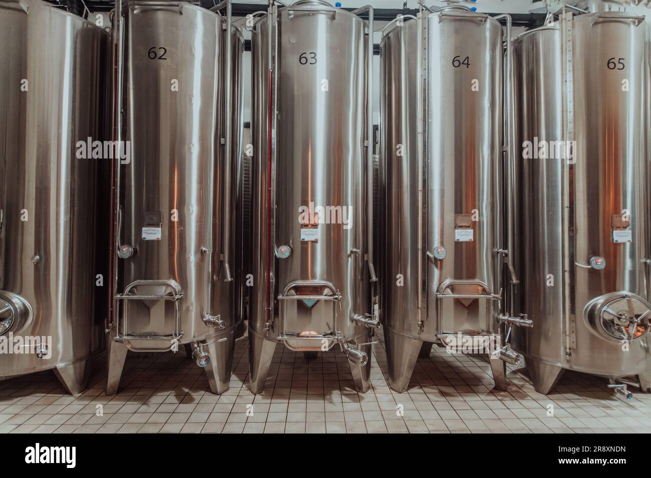 Modern wine distillery and brewery with brew kettles pipes and ...