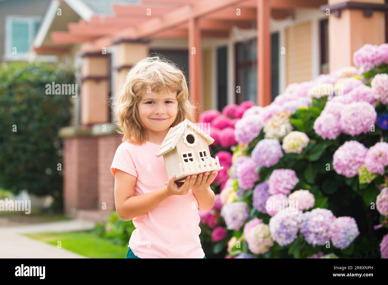 Kid child dreaming of new home. Happy boy holding dream house in their ...