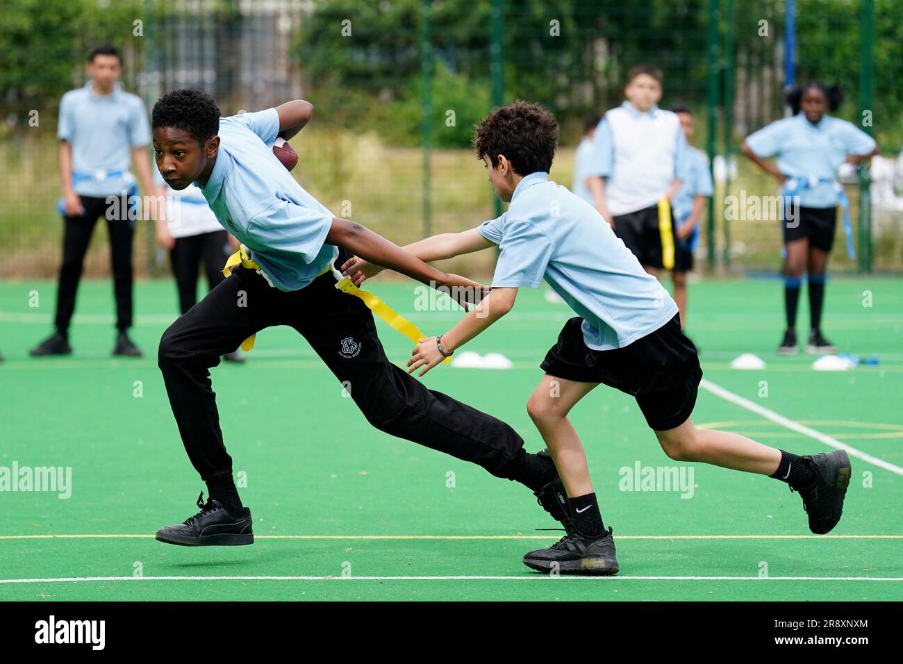 Students play American Football while waiting for NFL players to arrive ...
