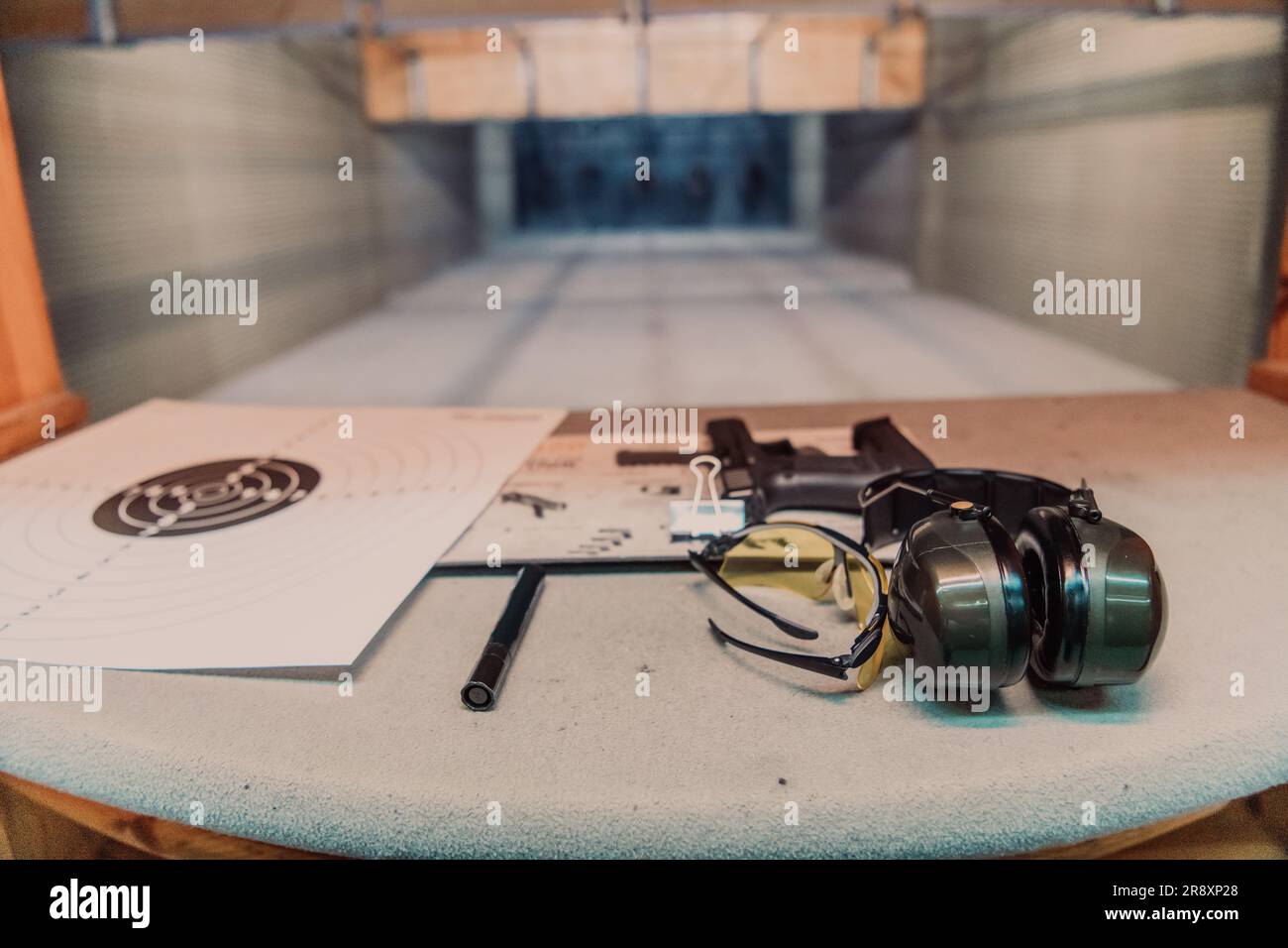 Shooting equipment in front of the target. Pistol, goggles and ...