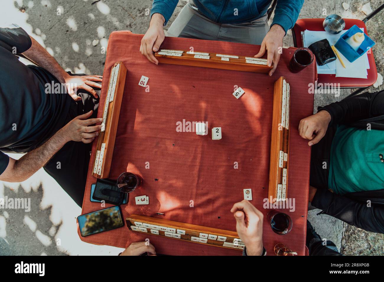 A group of men drink traditional Turkish tea and play a Turkish game ...
