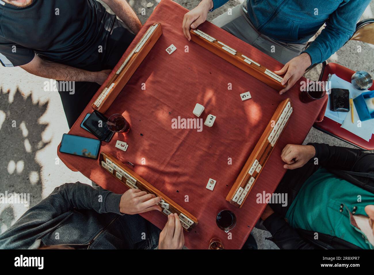 A group of men drink traditional Turkish tea and play a Turkish game ...