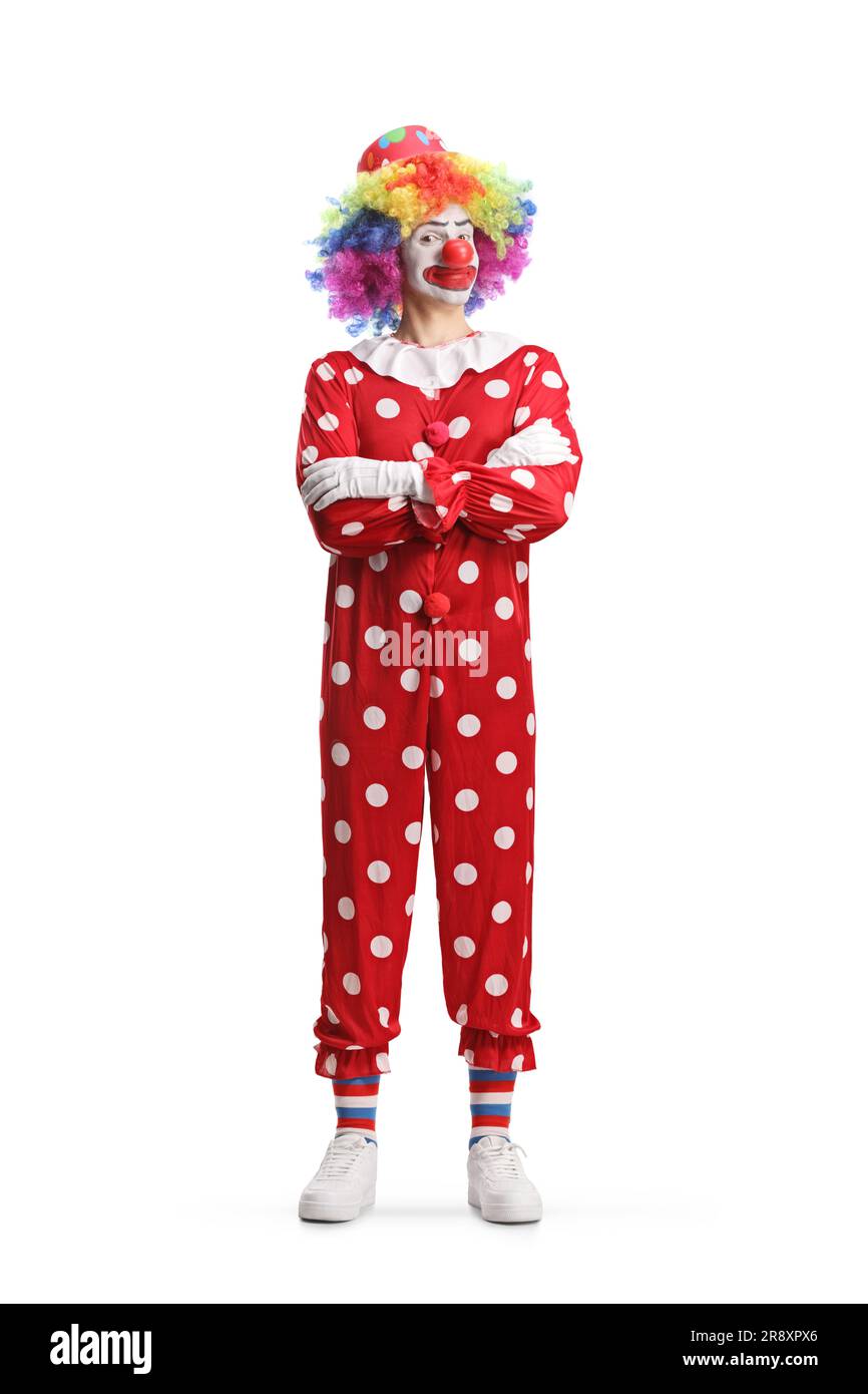 Full length portrait of a clown standing with folded arms isolated on ...