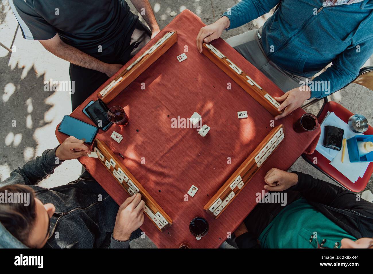 A group of men drink traditional Turkish tea and play a Turkish game ...